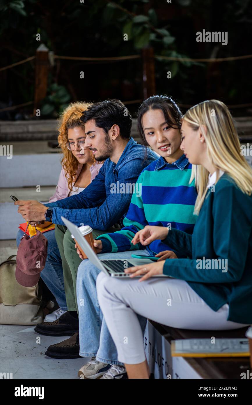 Group of student siting in campus learning together Stock Photo - Alamy