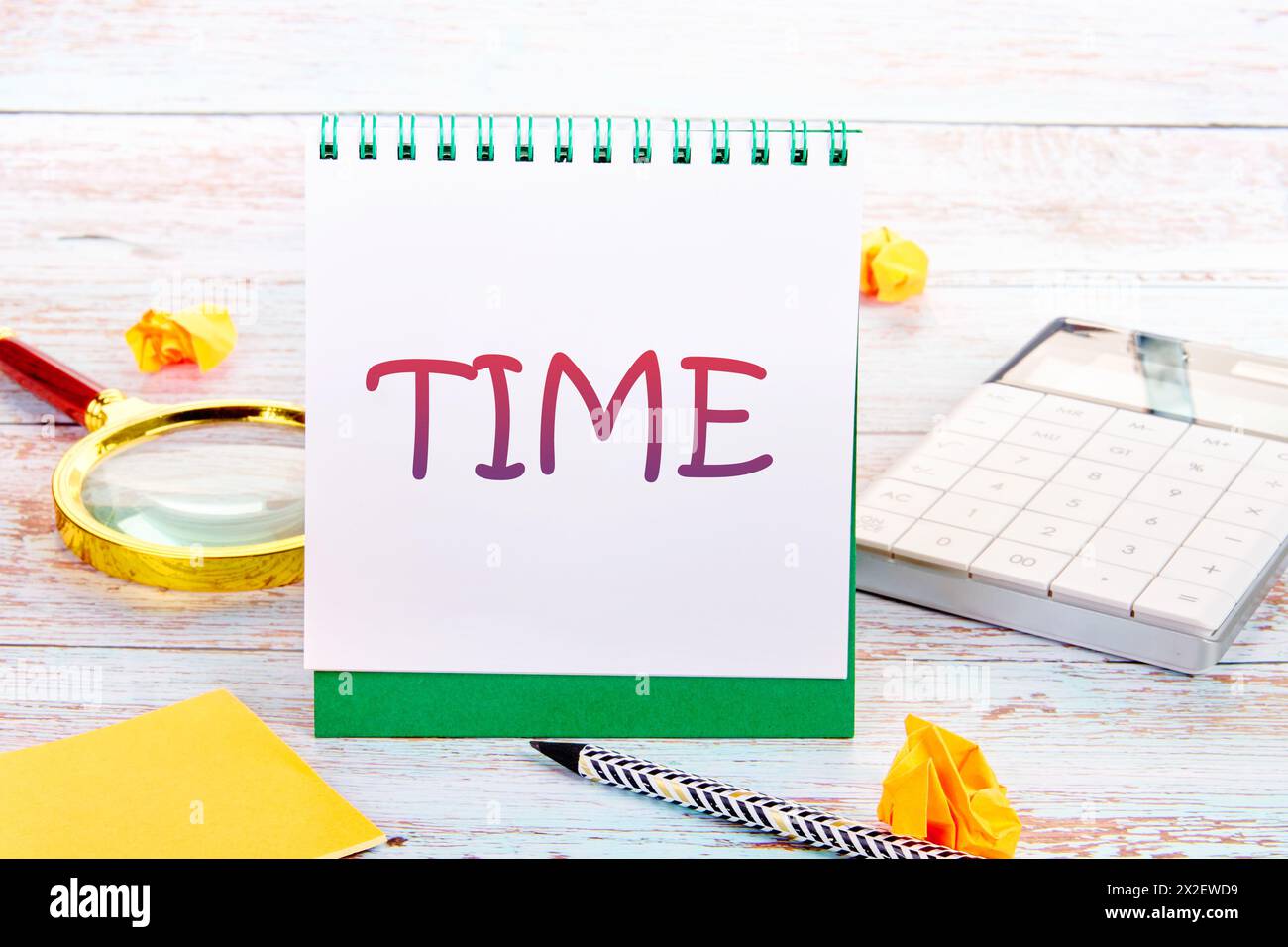 Time Concept TIME TEXT in a notebook next to a calculator, magnifying ...