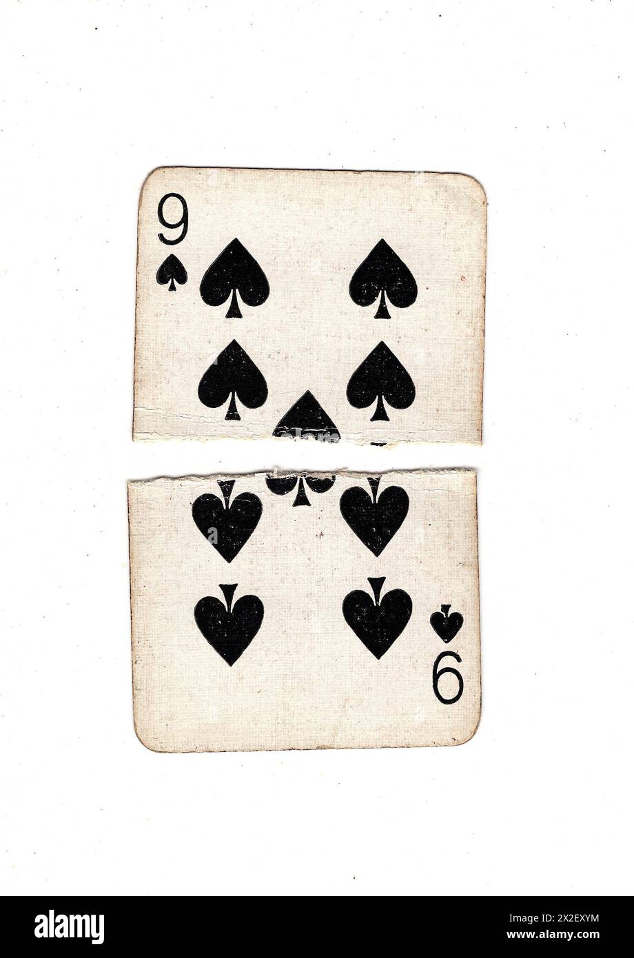 A vintage, well used nine of spades playing card torn in half on a ...