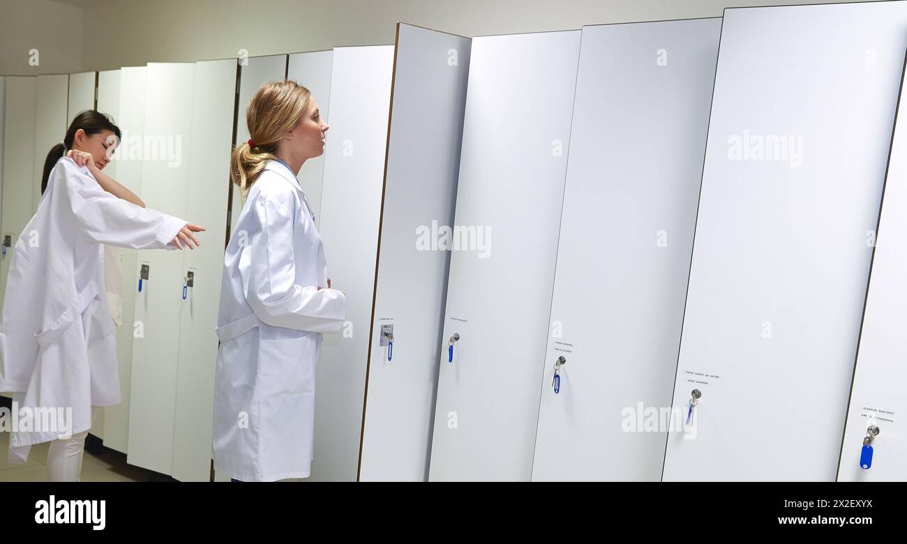 Researchers in the dressing room. White coats. Technological Services ...