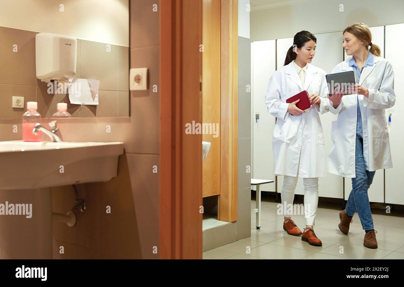 Researchers in the dressing room. White coats. Technological Services ...