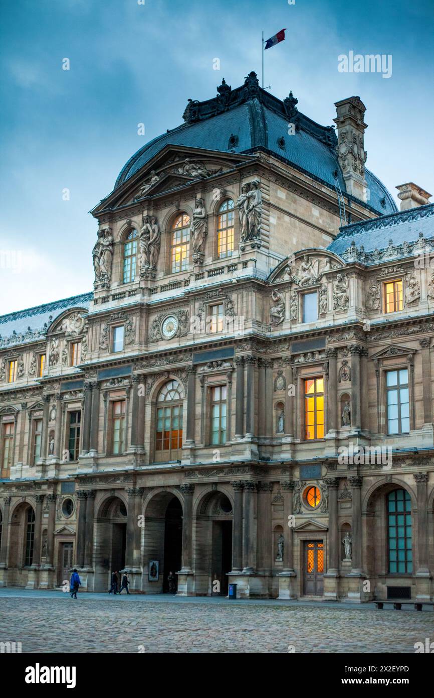 Evening glow on the Louvre's historic facade Stock Photo - Alamy