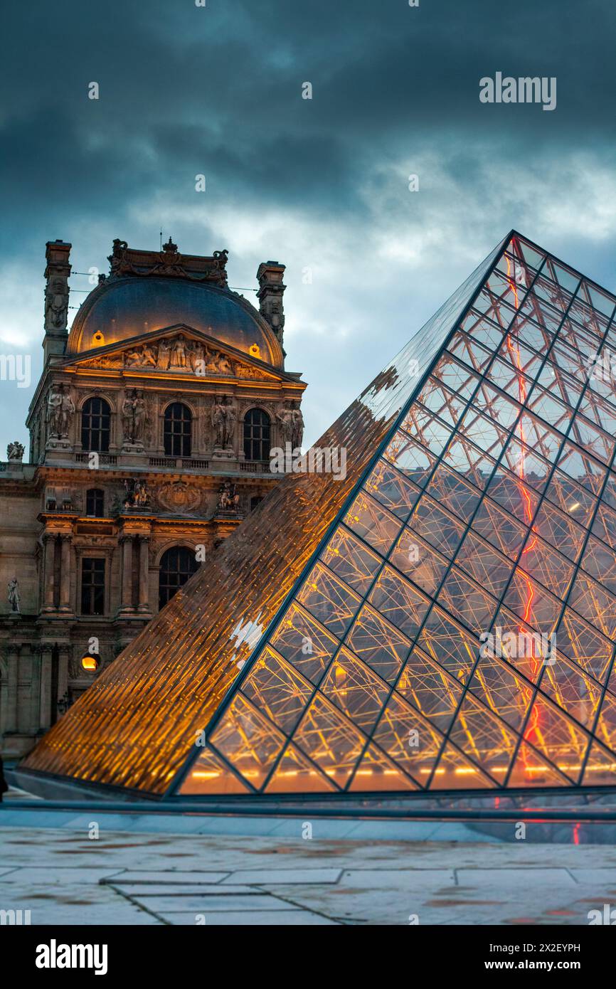 Stormy skies over the Louvre Pyramid at dusk Stock Photo - Alamy