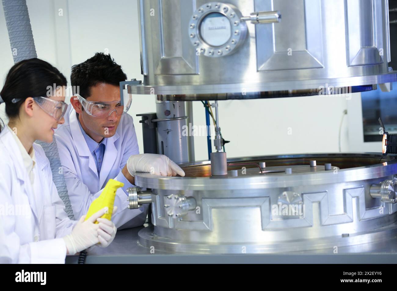 Researchers. Active screen plasma nitriding system. Vacuum chamber. Laboratory surfaces ...