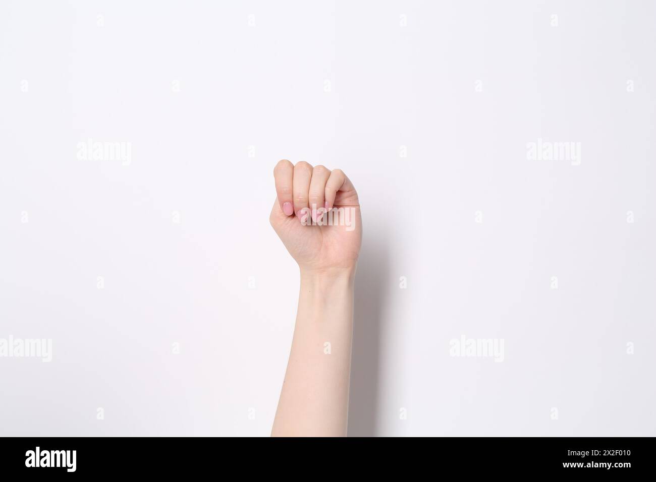 SOS gesture. Woman showing signal for help on white background, closeup ...