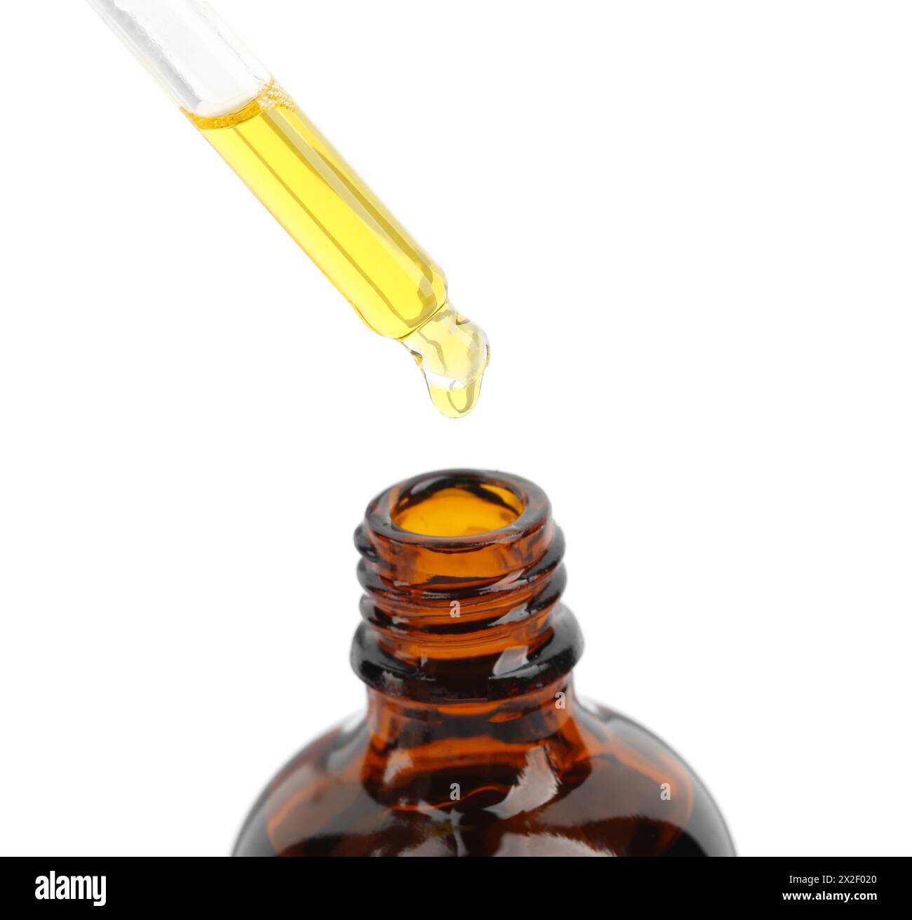 Dripping tincture from pipette into bottle isolated on white Stock ...