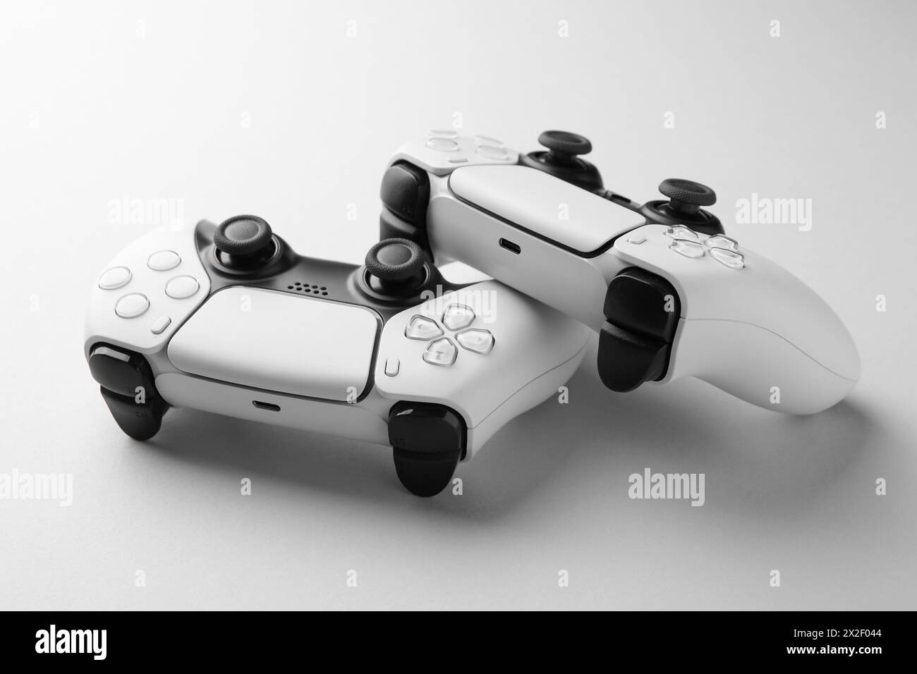 Wireless game controllers on light grey background Stock Photo - Alamy