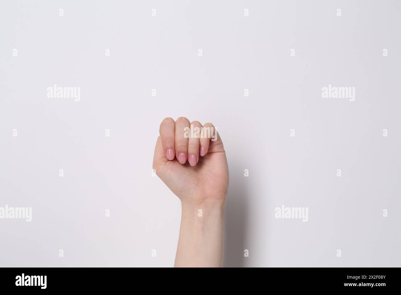 SOS gesture. Woman showing signal for help on white background, closeup ...