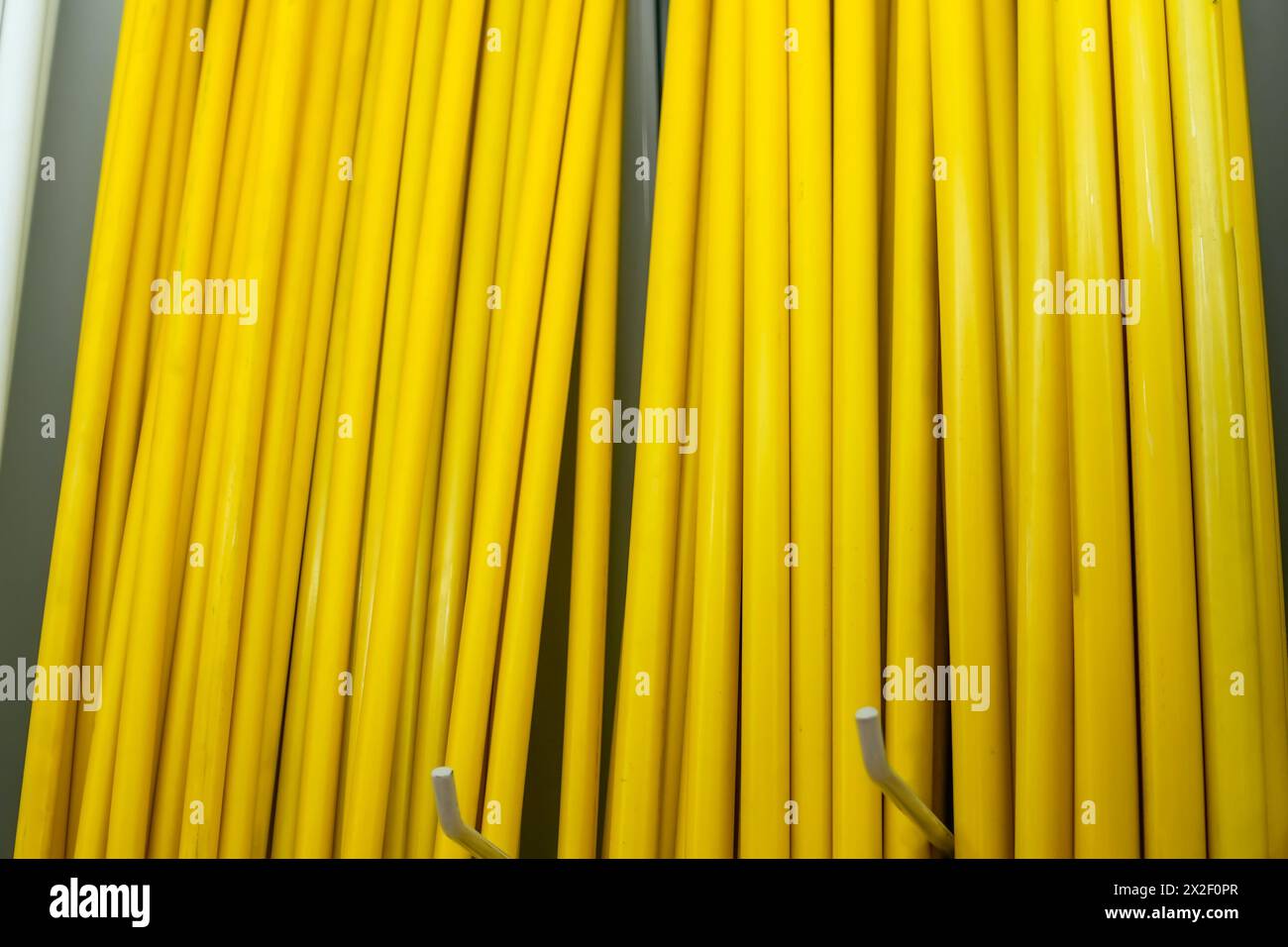 Various yellow plastic pipes on the counter in a store Stock Photo - Alamy