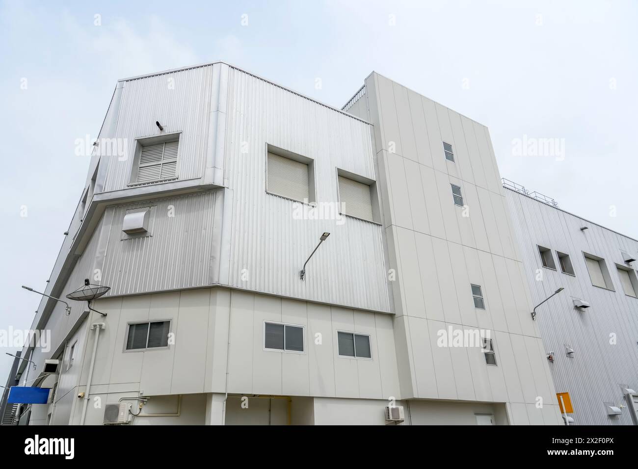 Modern exterior of white industrial building Stock Photo - Alamy