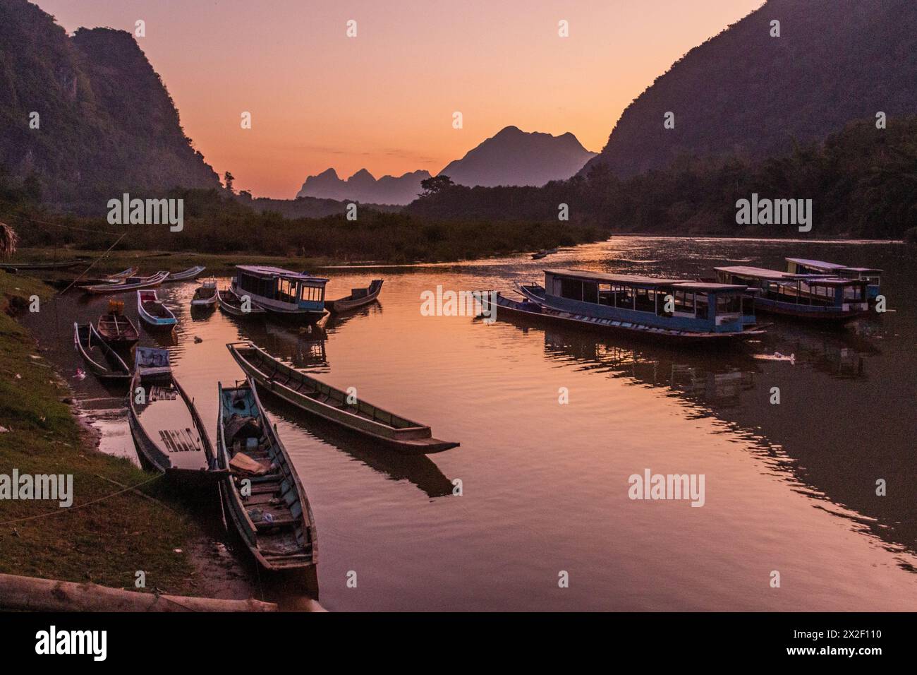 Sunset view of boats at Nam Ou river in Muang Ngoi Neua village, Laos ...
