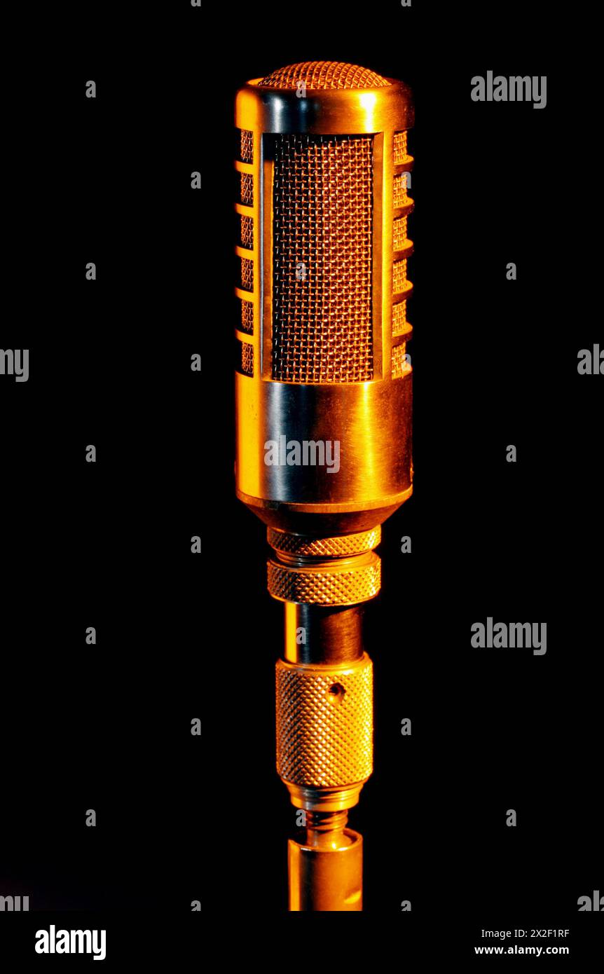 Retro fifties ribbon mic lit by golden spotlights Stock Photo - Alamy