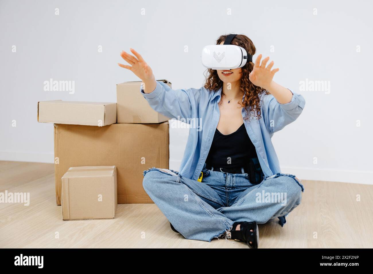 Young woman in VR glasses using modern technology creating room design ...