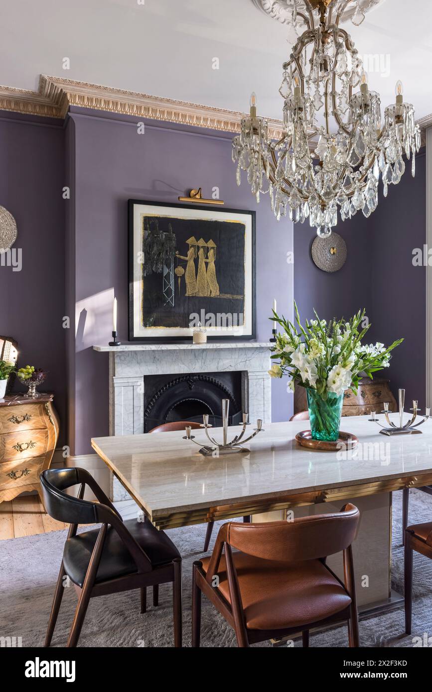Crystal chandelier above cut flowers on dining table in Georgian ...