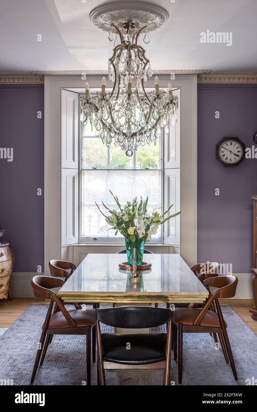 Crystal chandelier above cut flowers on dining table in Georgian ...