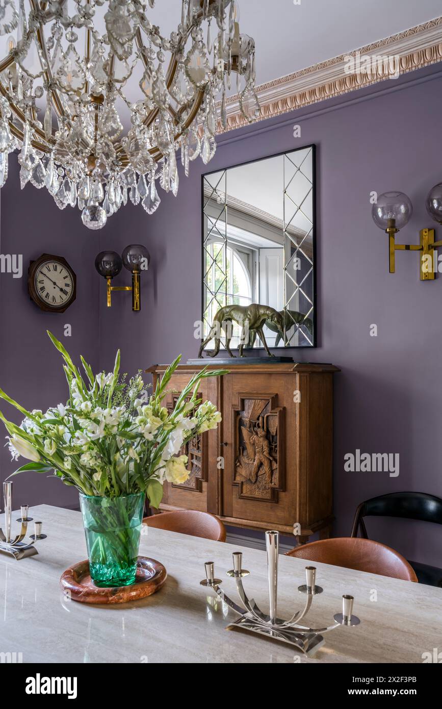 Crystal chandelier above cut flowers on dining table in Georgian ...