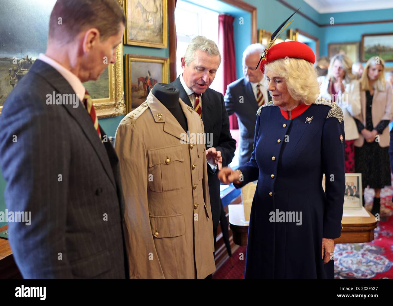 Queen camilla views the tunic belonging to her late father major bruce ...