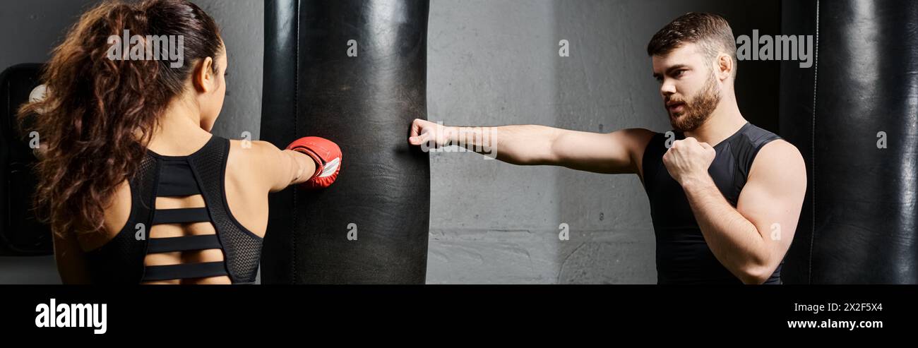 A male trainer guides a brunette sportswoman in active wear through ...