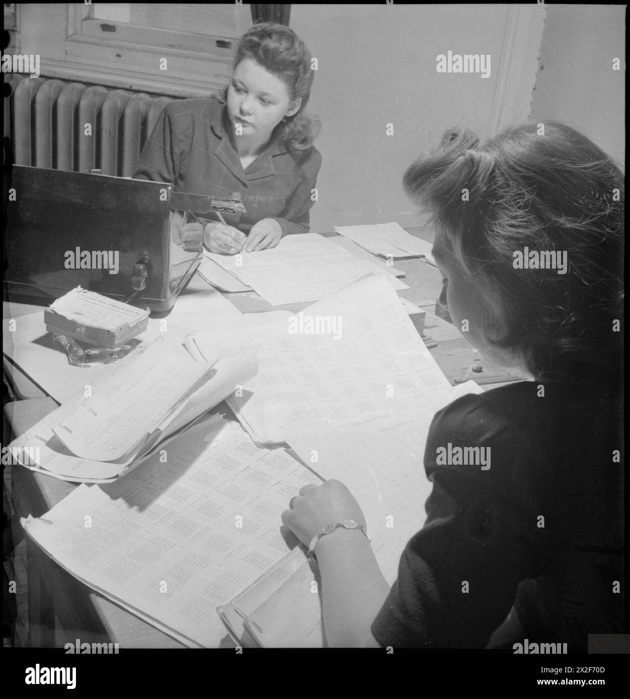 Staff at the Wartime Social Survey in Britain, 1944, collate ...