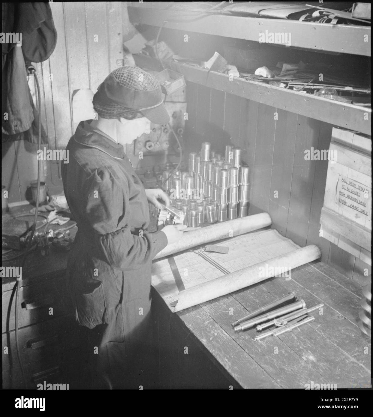 WAR INDUSTRY, UK, 1942 - A woman war worker uses a set of Wickman ...