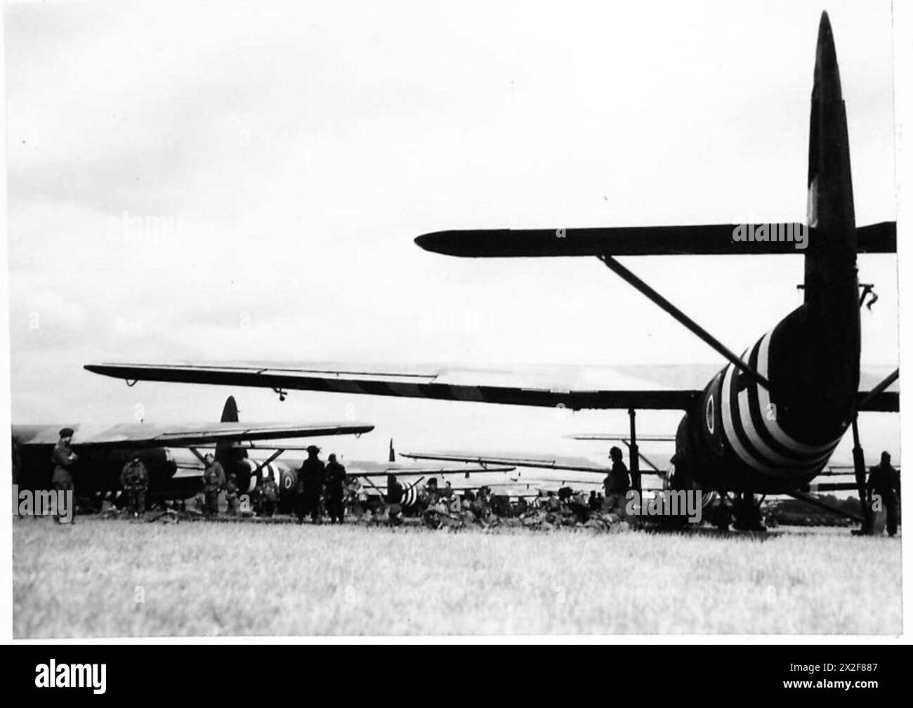 Troops of the 6th Airlanding Brigade wait beside Horsa gliders at an ...