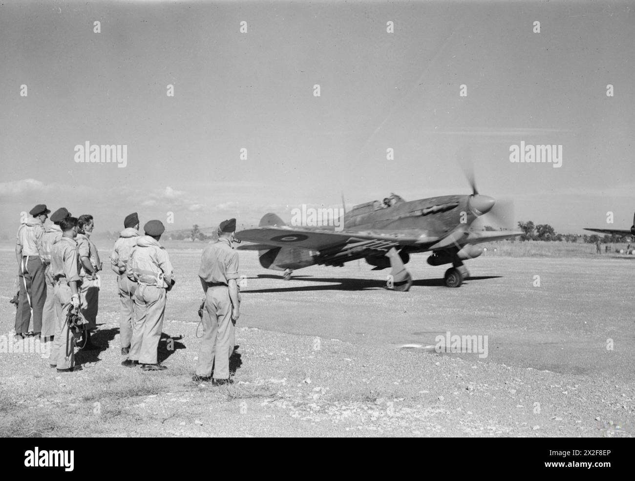 Pilots of No. 32 Squadron RAF observe a Hawker Hurricane Mark IV of No ...