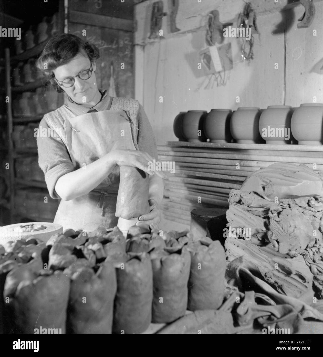 Mrs. Hilda Adams shapes red clay to create teapot moulds at J & G ...