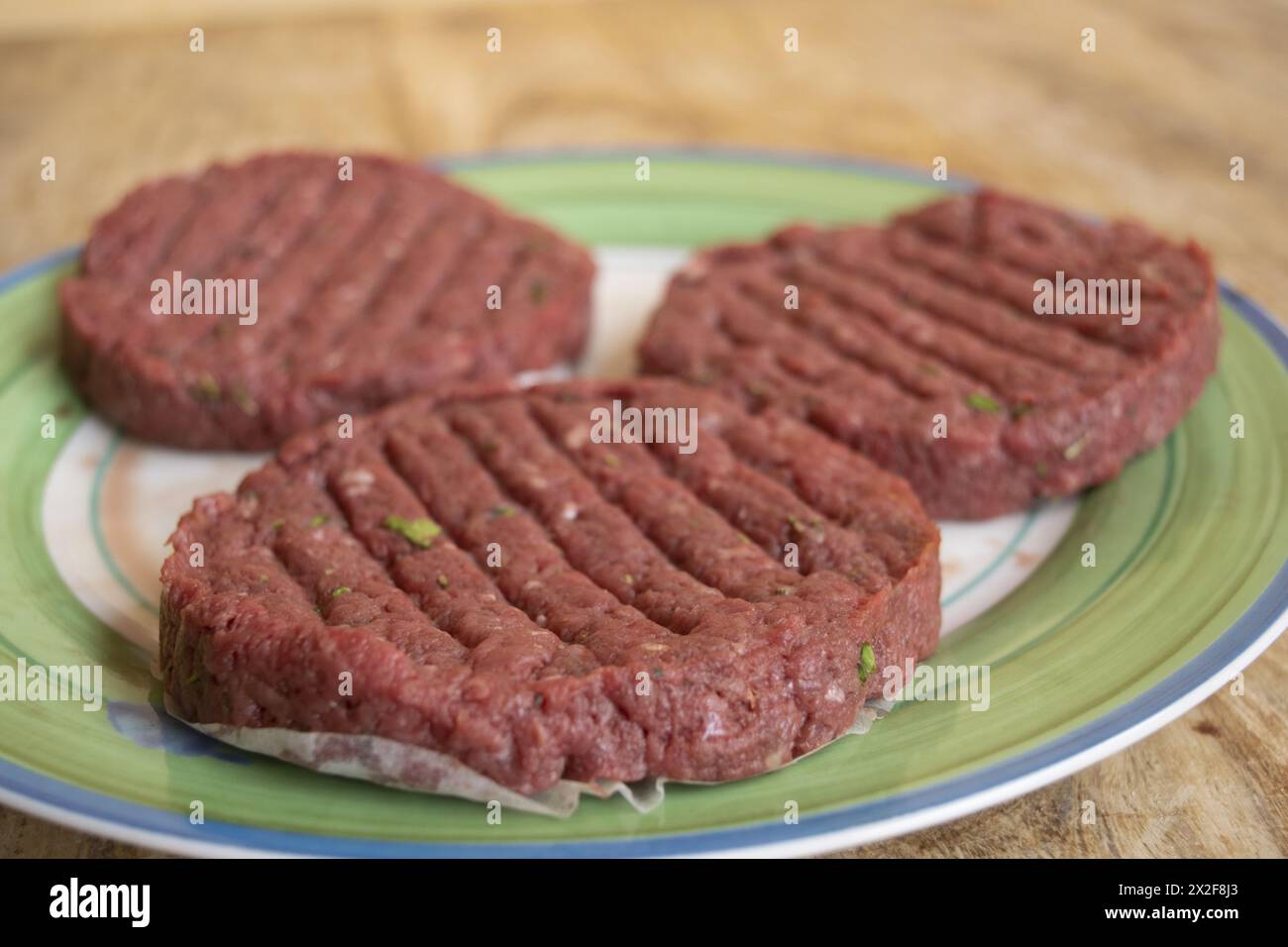 raw beef hamburger ready to be cooked in a dish Stock Photo - Alamy