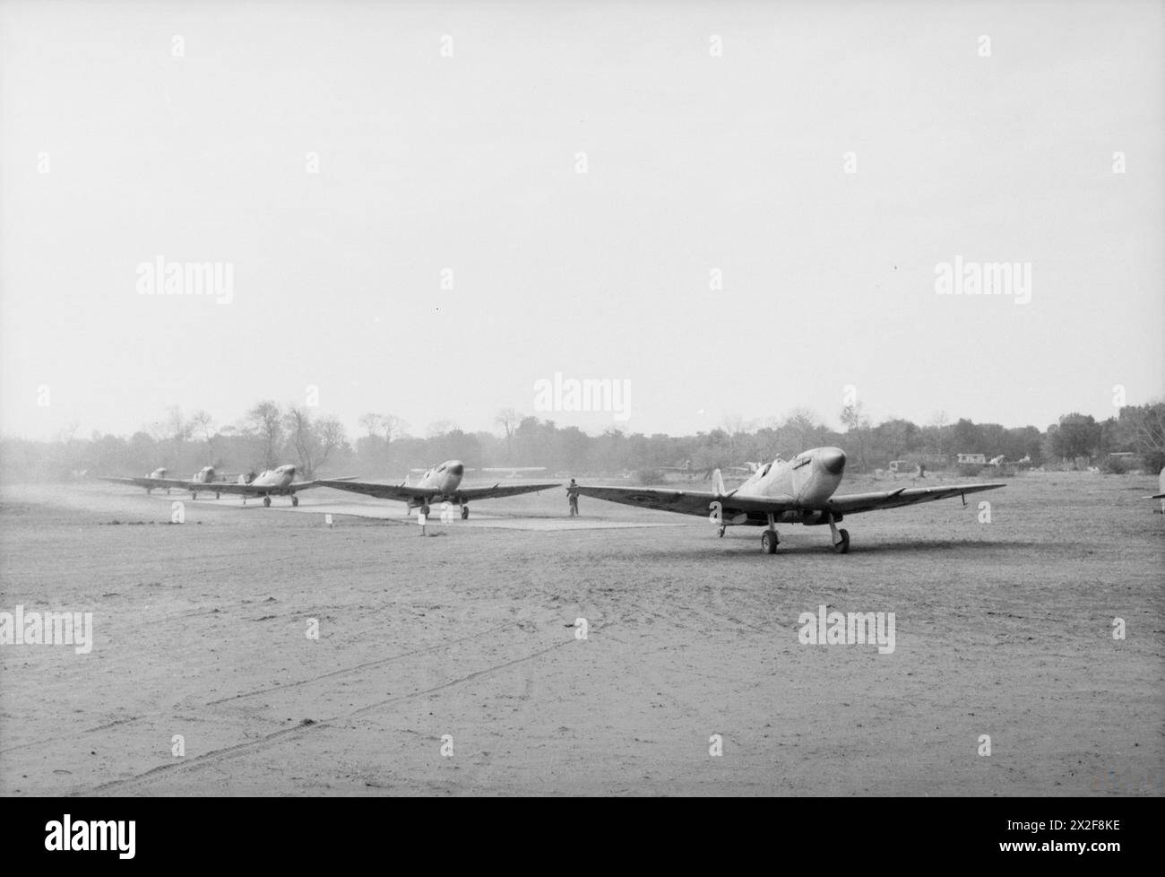 Supermarine Spitfire Mark IXs of No. 324 Wing RAF taxi to the runway at ...