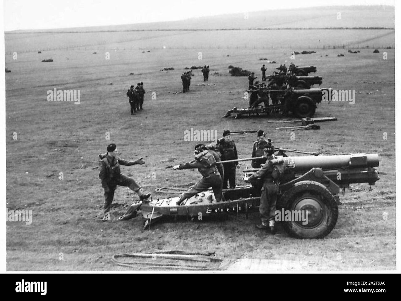 IN BONNIE SCOTLAND - The gunners in action. Ramming home the shells ...