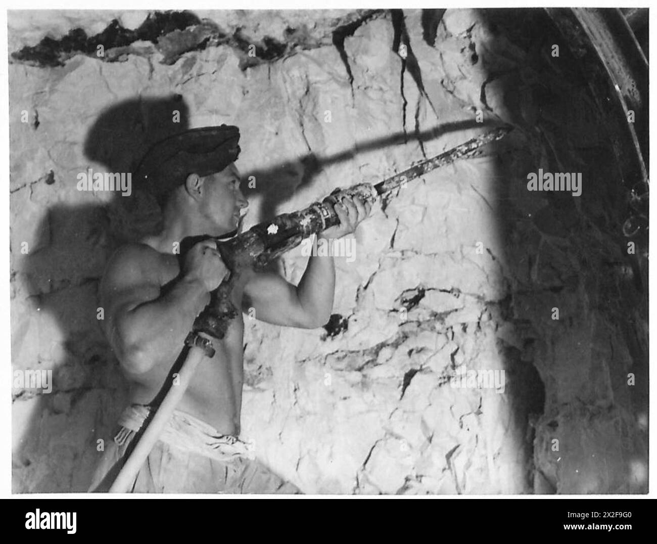 A British Army sapper excavates a subterranean operations center using ...