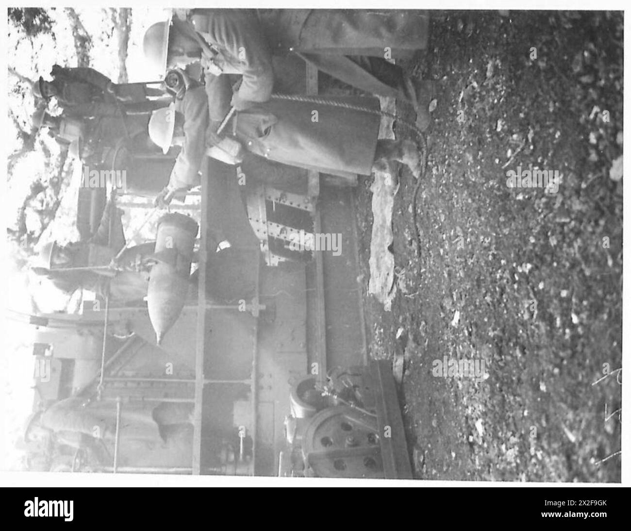 ONE OF BRITAIN'S TEETH - A shell being hoisted on to the loading cradle ...