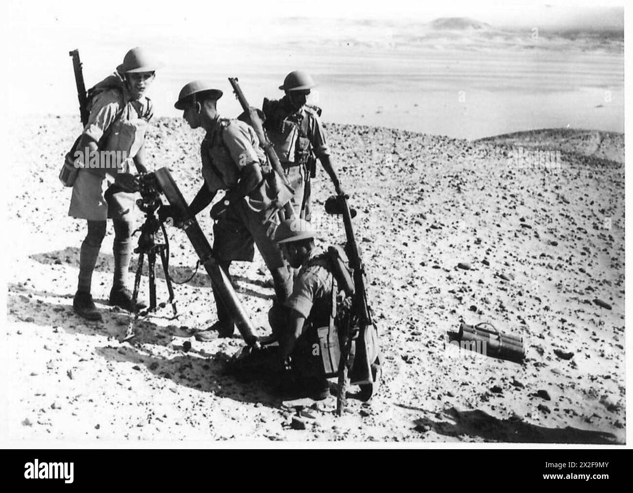 Indian soldiers assemble a trench mortar in desert training exercises ...