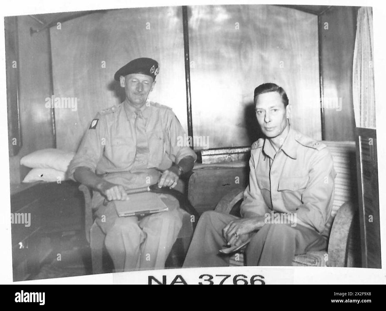 HIS MAJESTY AT GENERAL MONTGOMERY'S BATTLE H.Q. - Inside the caravan His Majesty is seen with ...
