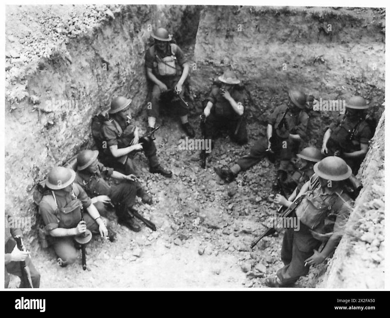 Royal Scots Fusiliers wait in a trench armed with Tommy guns, prepared ...