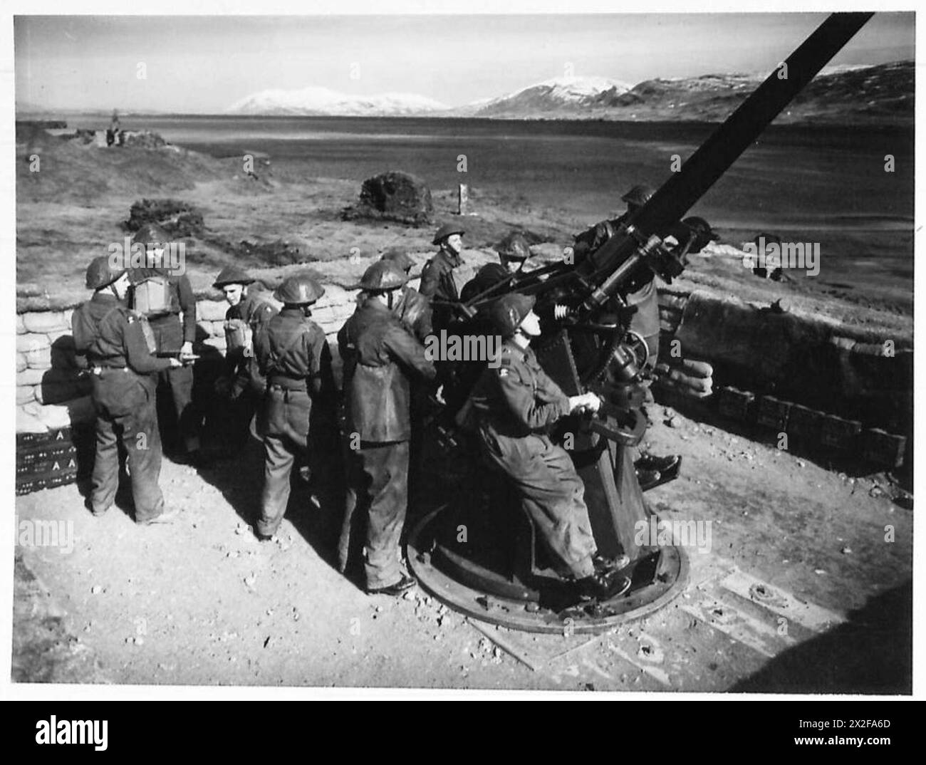 British Army gunners in Iceland operate a 3-inch anti-aircraft gun ...