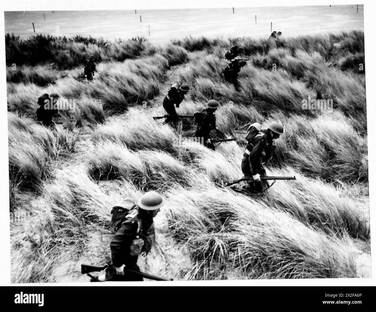 Belgian Army troops trained by advancing as a squad under cover of whin ...