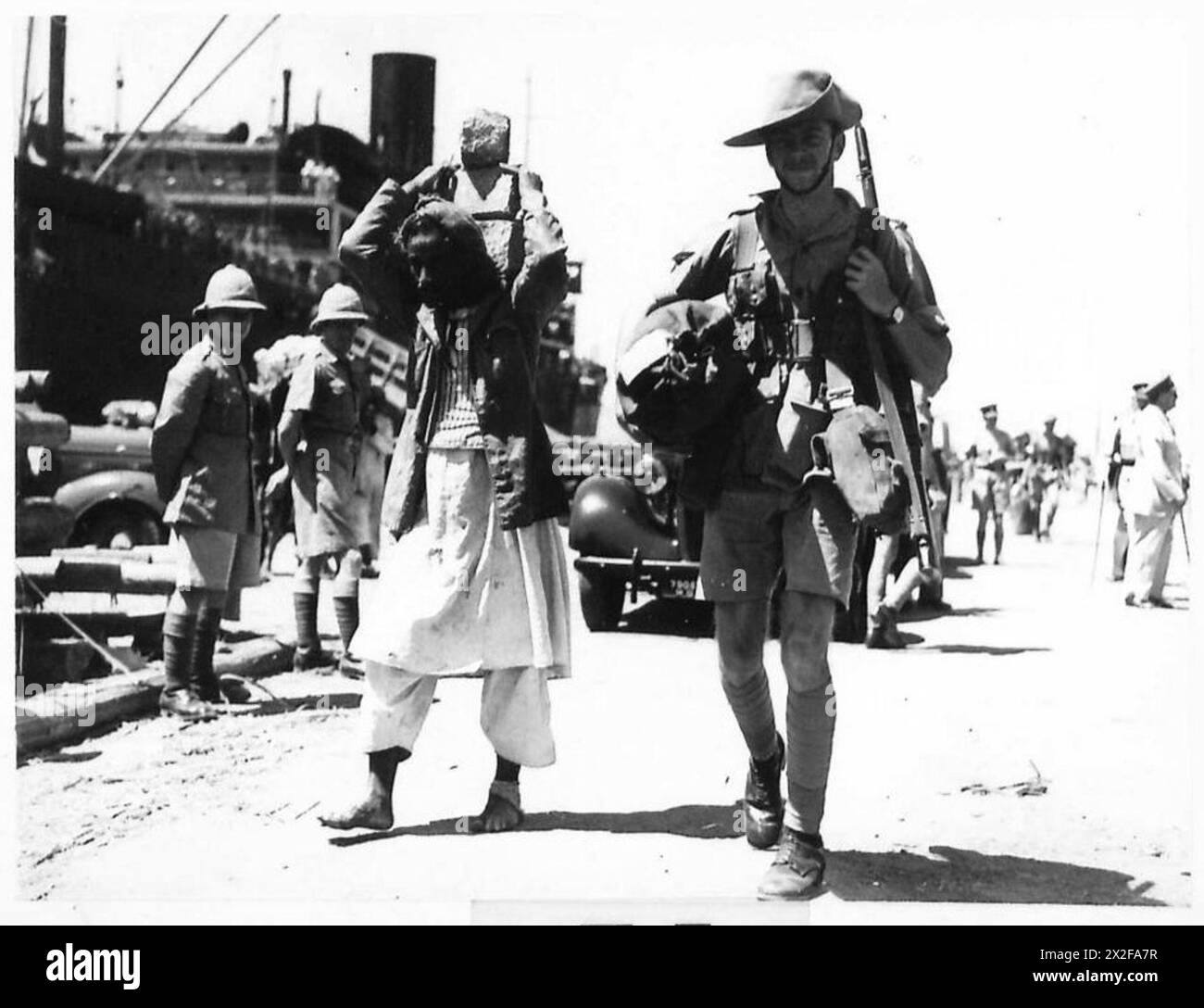 A Southern Rhodesian troop arrival is contrasted by a native labourer ...