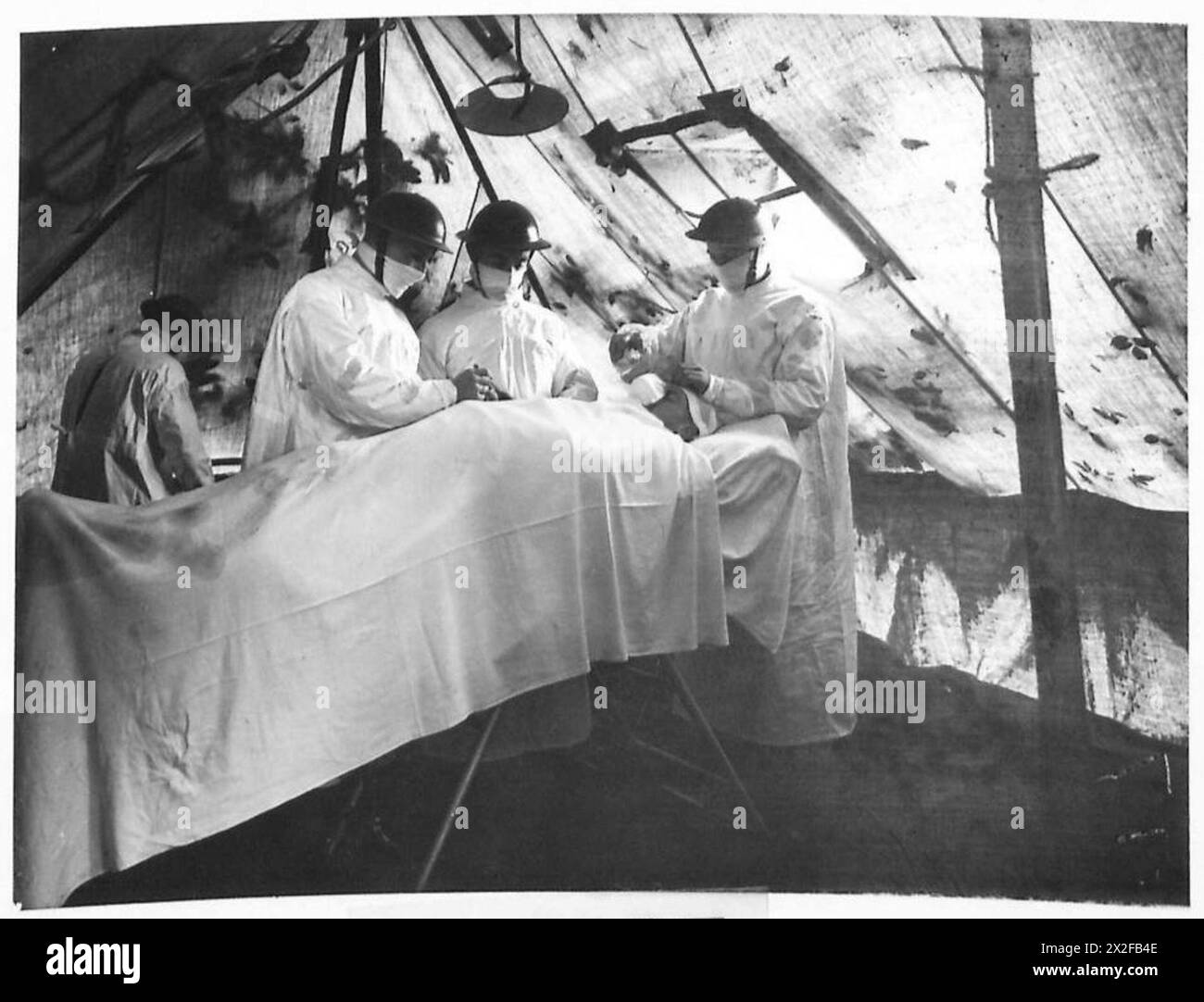 THEY FIGHT TO SAVE LIFE AND LIMB - In the rain-sodden tent improvised ...