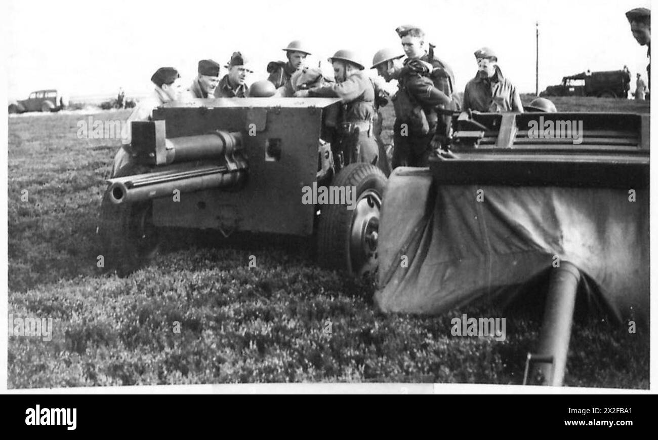 On the Yorkshire Moors, spectators observe the operation of 75 mm guns ...