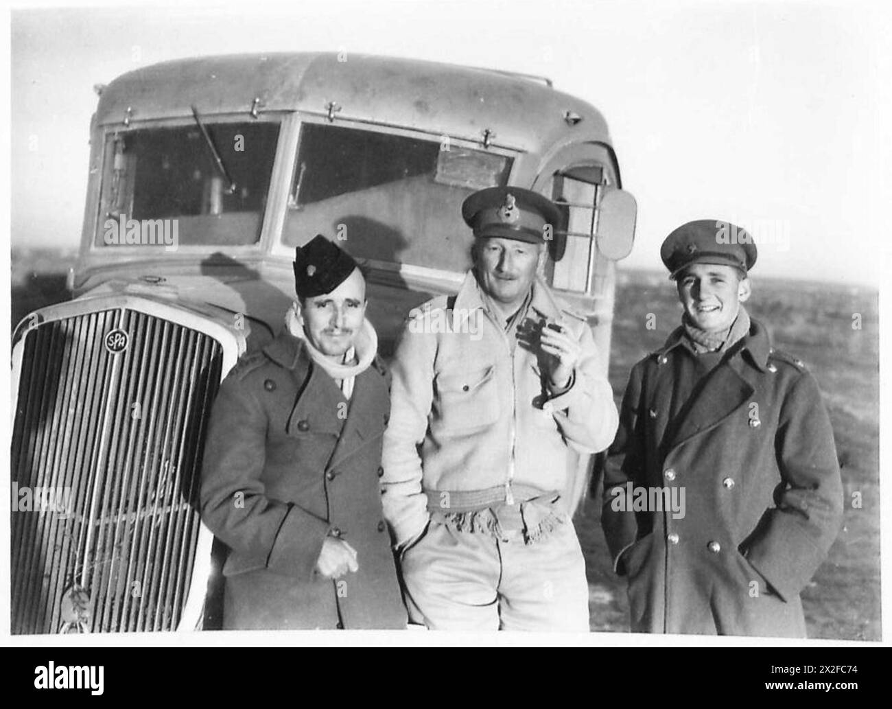 The General Officer Commanding of an Indian Division stands with two ...