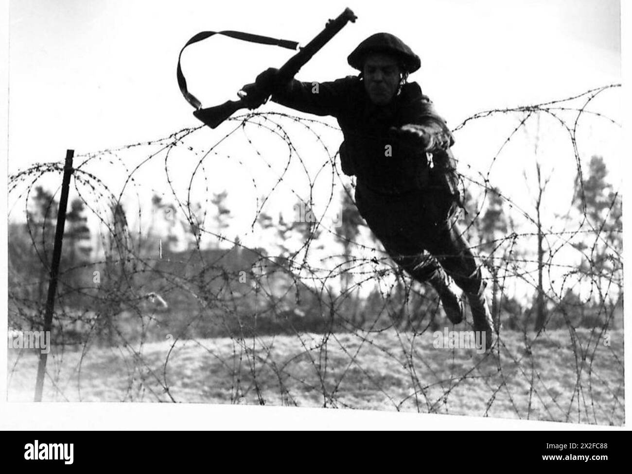 COMMANDOS IN TRAINING - Demonstrating a quick way of crossing barbed ... COMMANDOS IN TRAINING - Demonstrating a quick way of crossing barbed ...