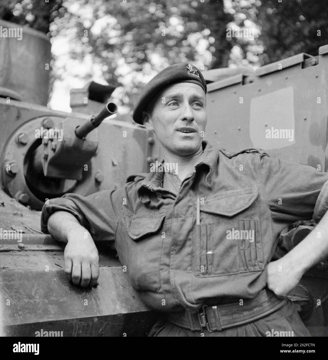 Trooper E. McGuiness serves as gunner on a Churchill tank of 'B ...