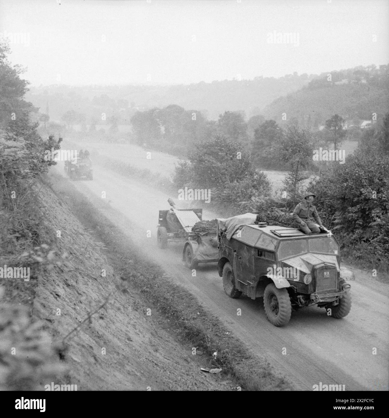 25-pounder artillery guns and Quad tractors of the British Army advance ...