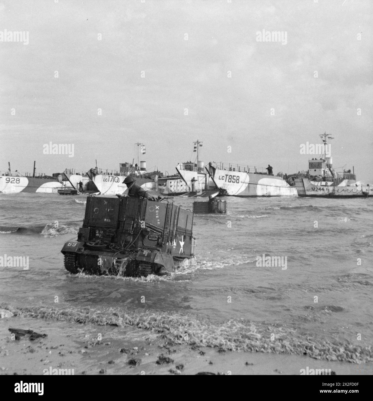 Universal Carriers of the 50th Division wade ashore from LCTs on Jig ...