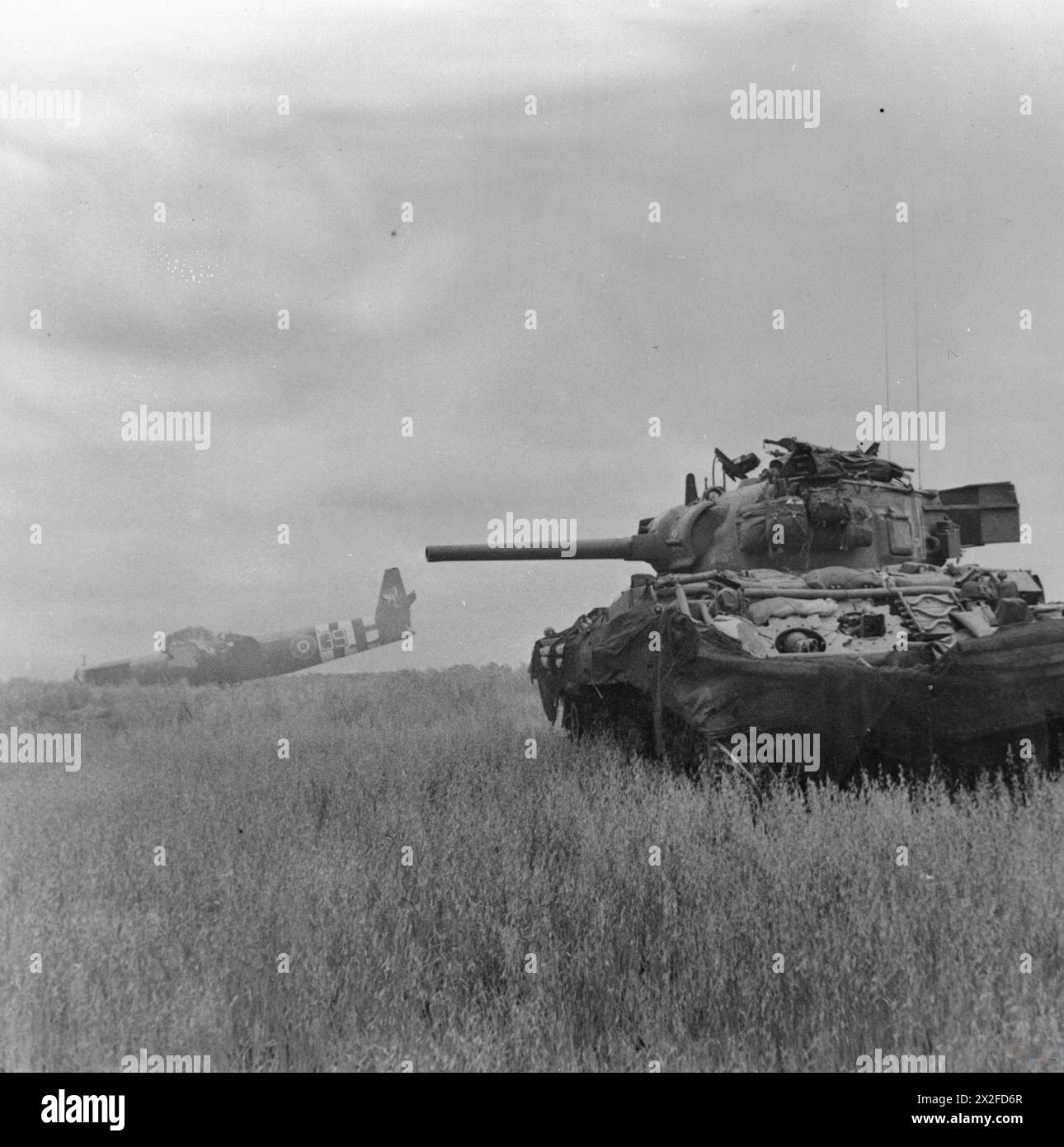 A Sherman tank of the 13th/18th Royal Hussars engages German troops ...