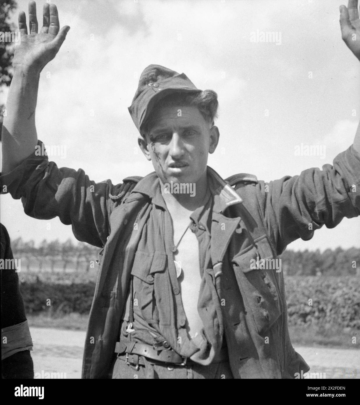 A German prisoner of war is captured by British forces in Belgium on 3 September 1944 during ...