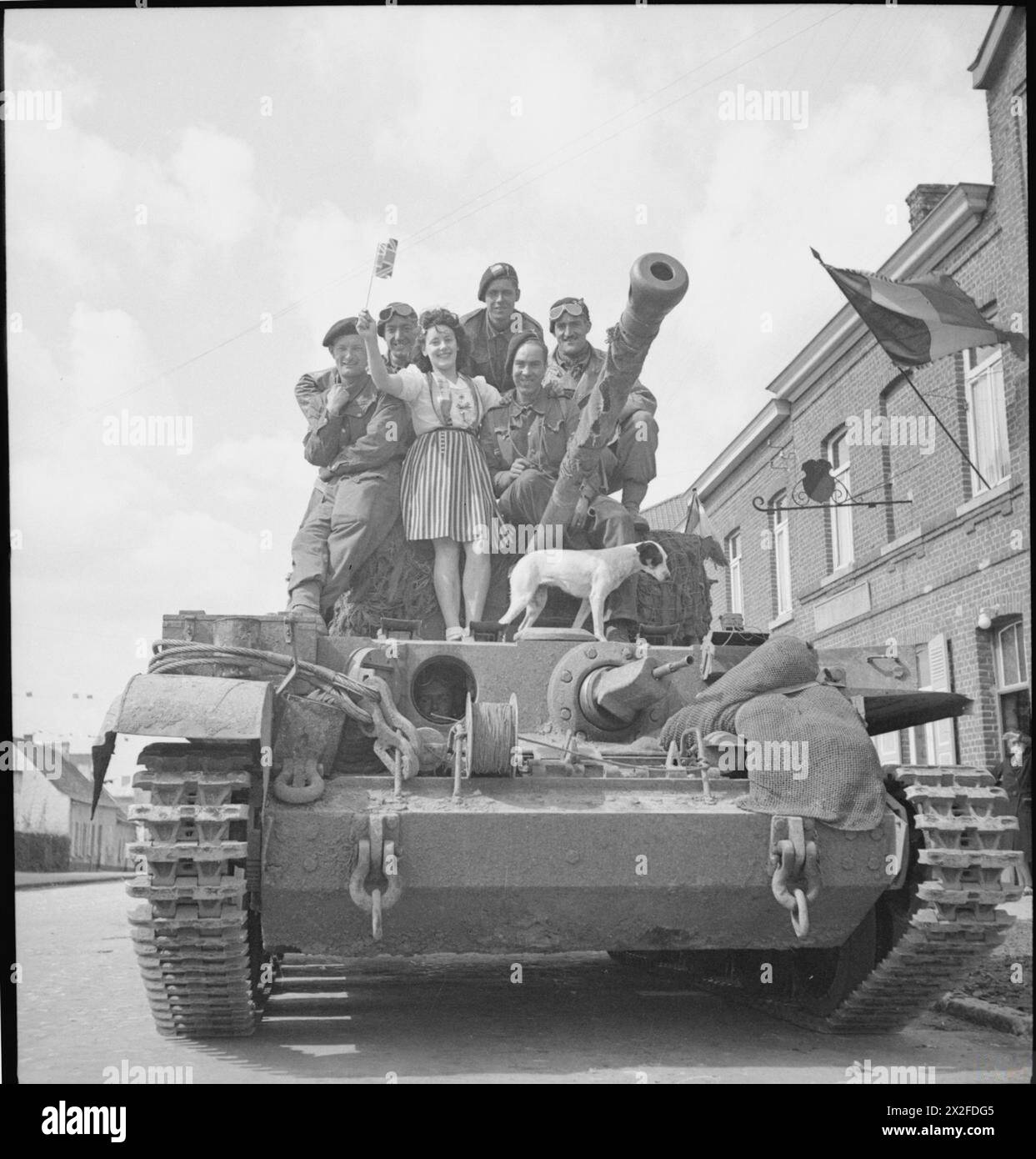 A young Belgian woman poses with the crew of a Cromwell tank in the ...