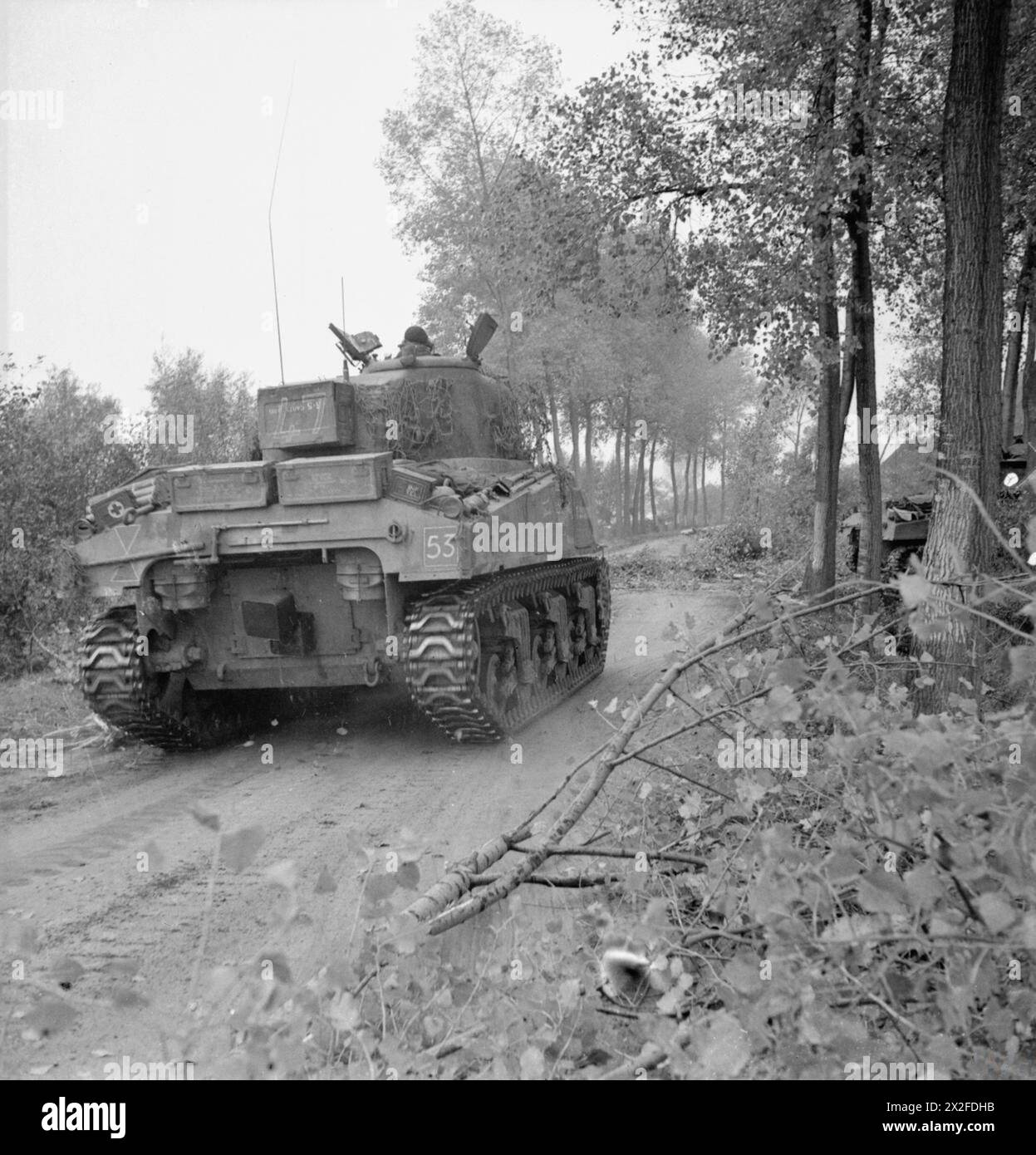 A Sherman tank of the 33rd Armoured Brigade advances in support of the ...