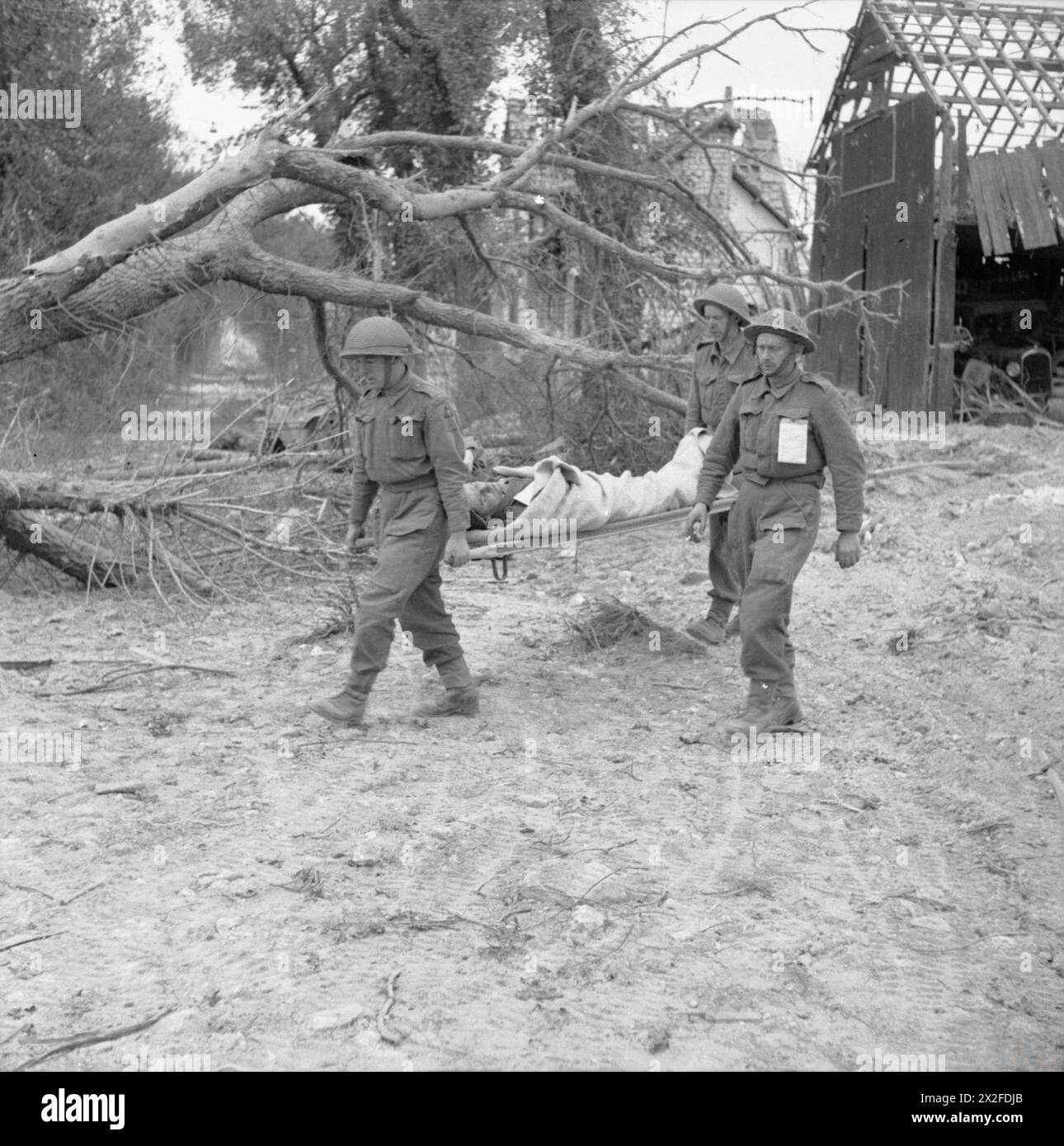 THE BRITISH ARMY IN NORMANDY 1944 - A casualty on a stretcher being ...